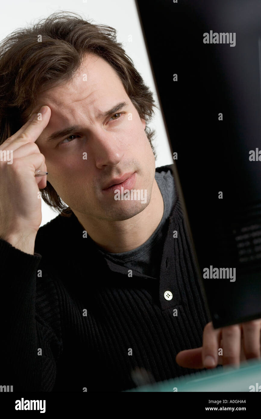 Perplexed man at computer Stock Photo - Alamy