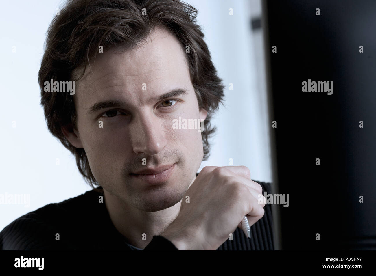 Serious man holding pen Stock Photo - Alamy