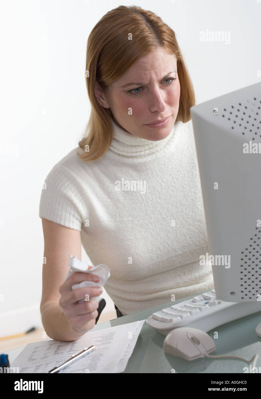 Distressed woman at desk with computer Stock Photo - Alamy