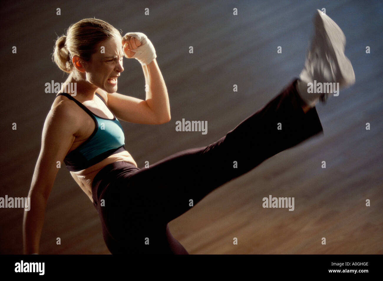 Side profile of a young woman kickboxing Stock Photo - Alamy
