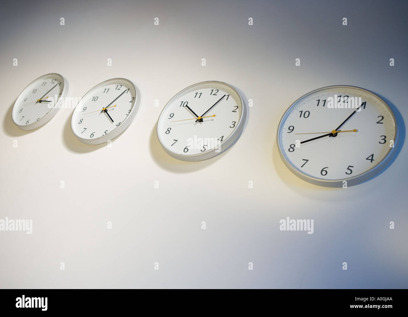 Row of clocks indicating different times Stock Photo - Alamy