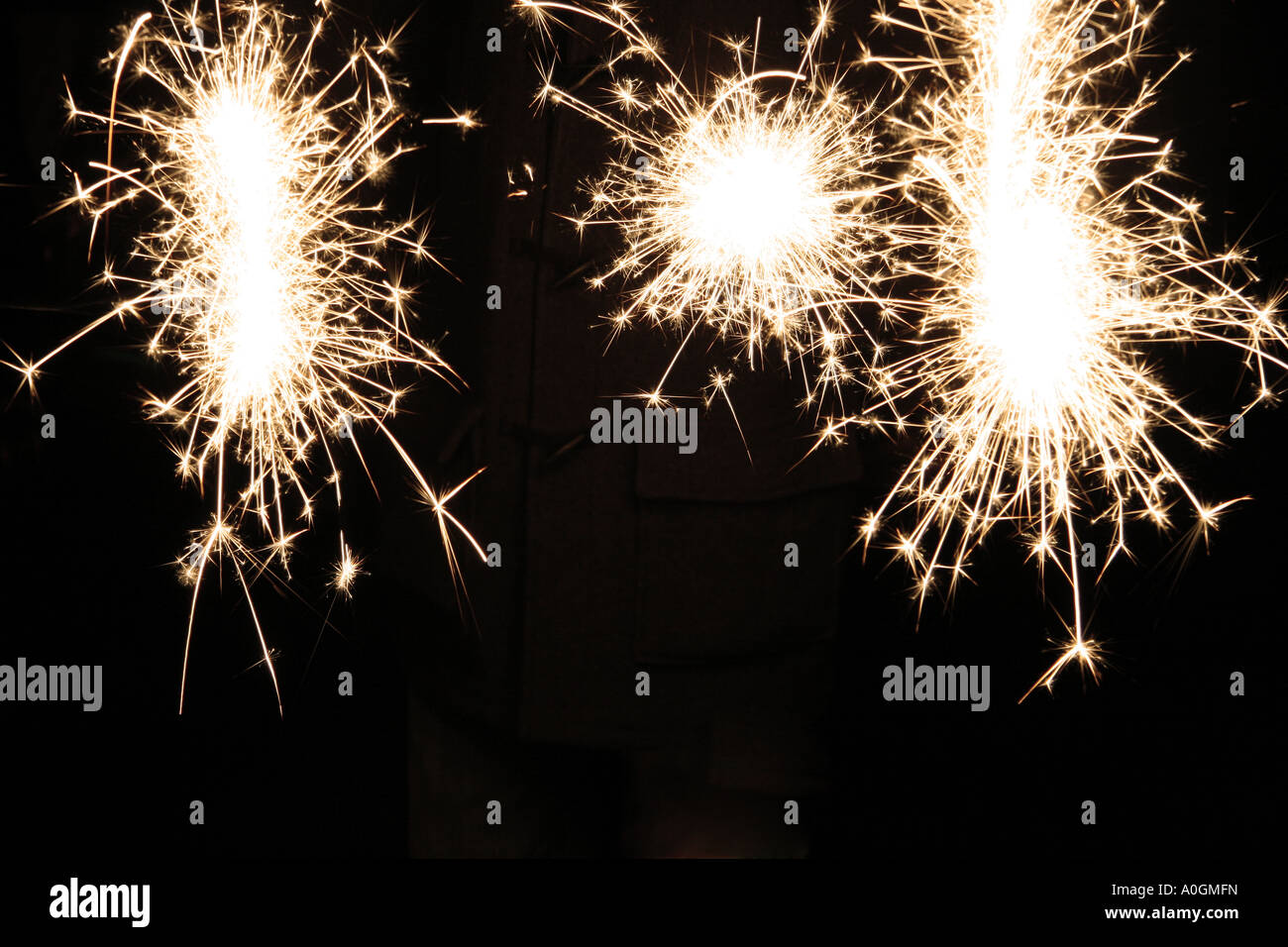 three fireworks going off in the night sky Stock Photo - Alamy