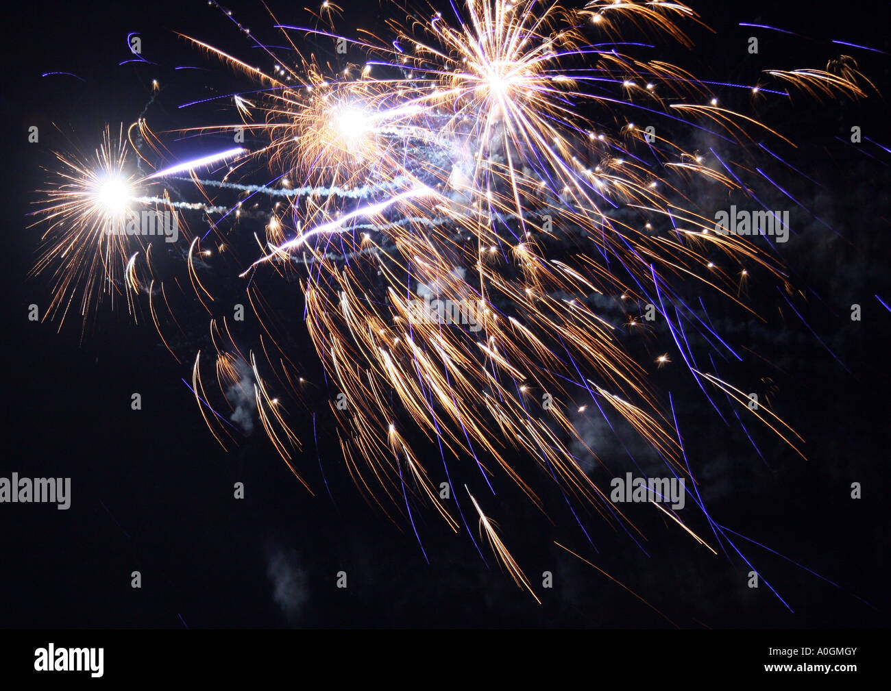 three rockets exploding into the sky Stock Photo - Alamy