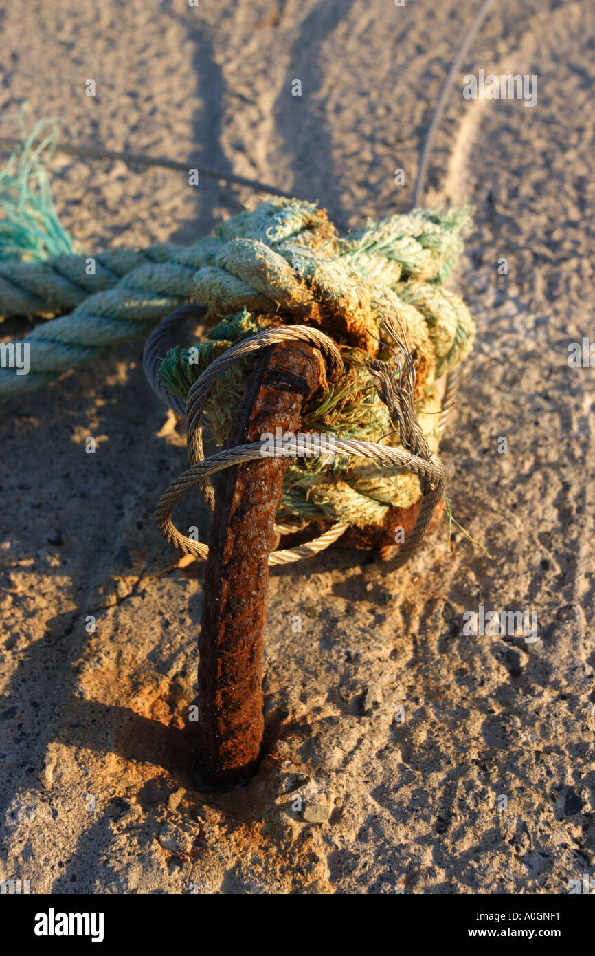 OLD ROPE ON A RUSTY ANCHOR BOLT ATTACHED TO STONEWORK Stock Photo - Alamy