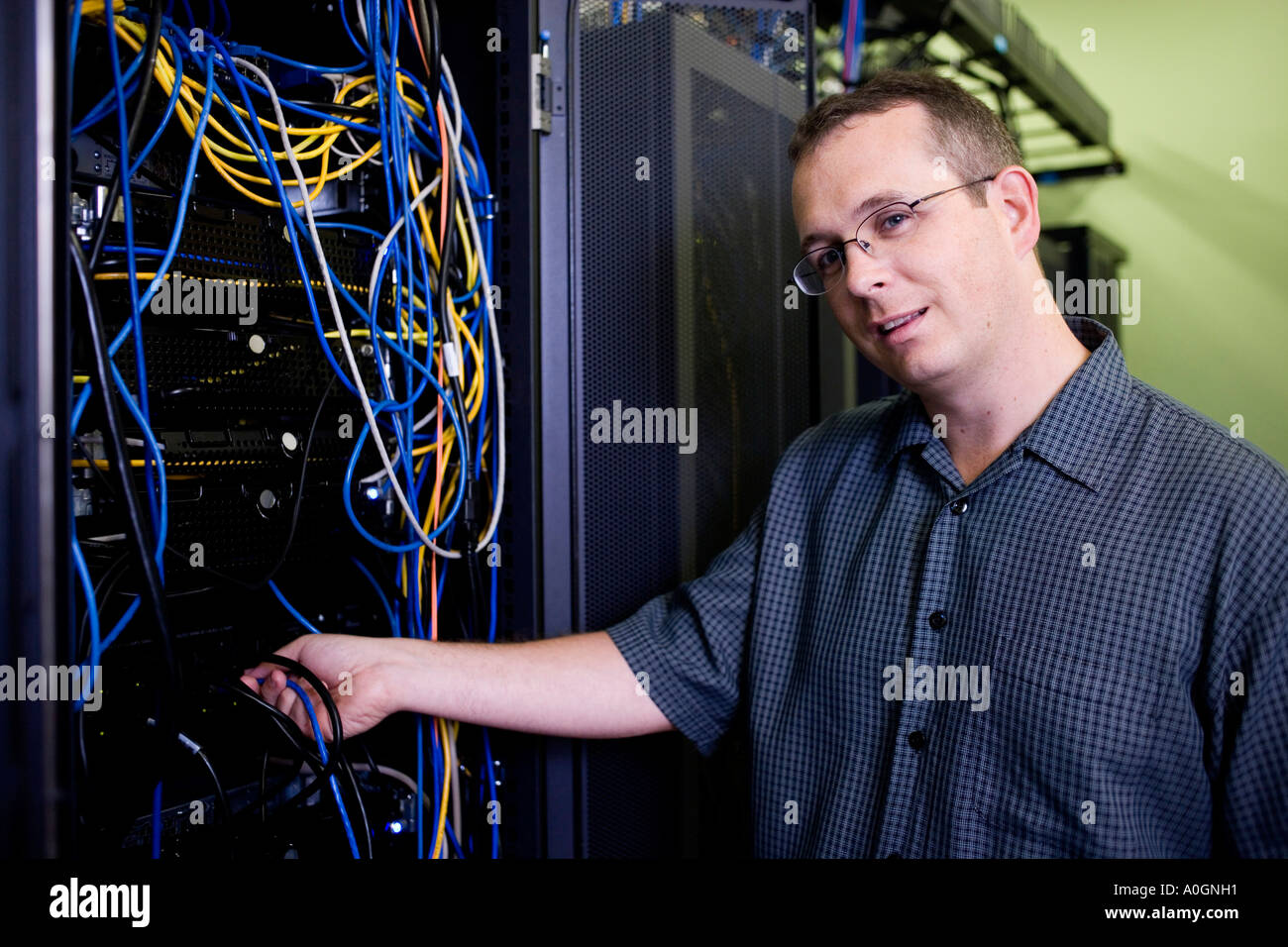 Portrait of a technician with computer cables in a server room Stock ...