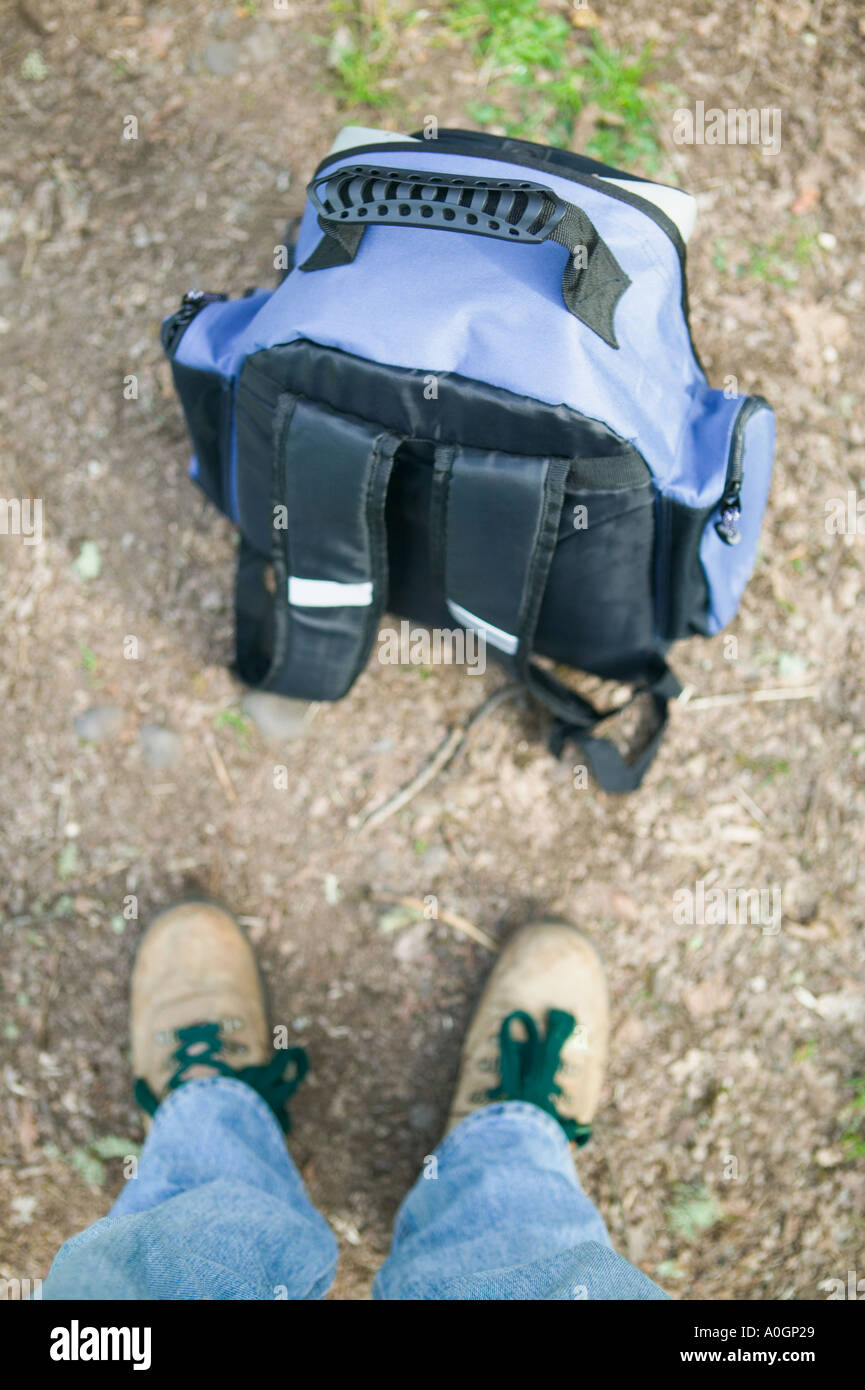 Hiker standing next to backpack on trail Stock Photo - Alamy