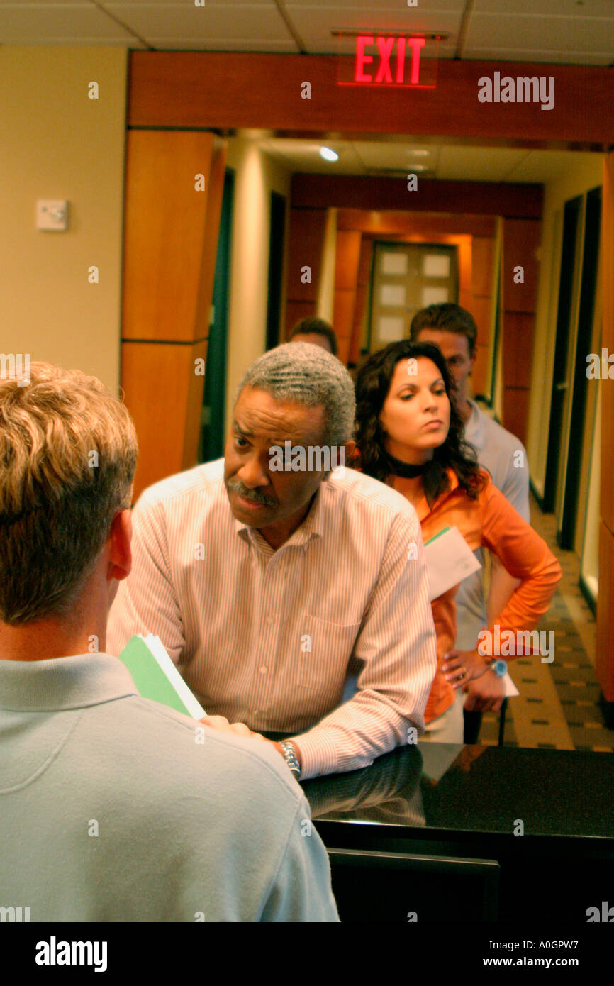 Group of business executives standing in a row at a bank counter Stock ...