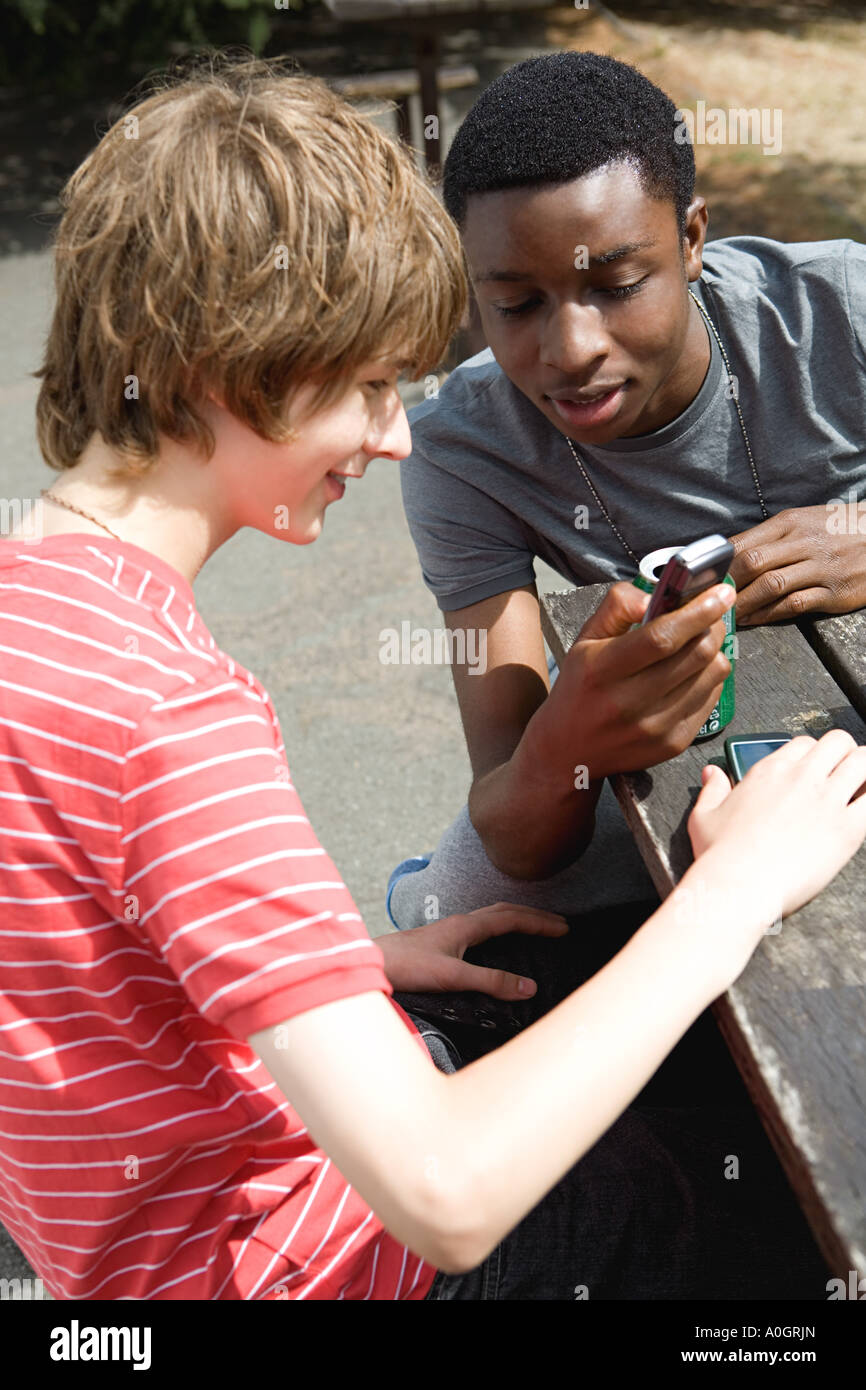 Teenage boys looking at cellphone Stock Photo - Alamy