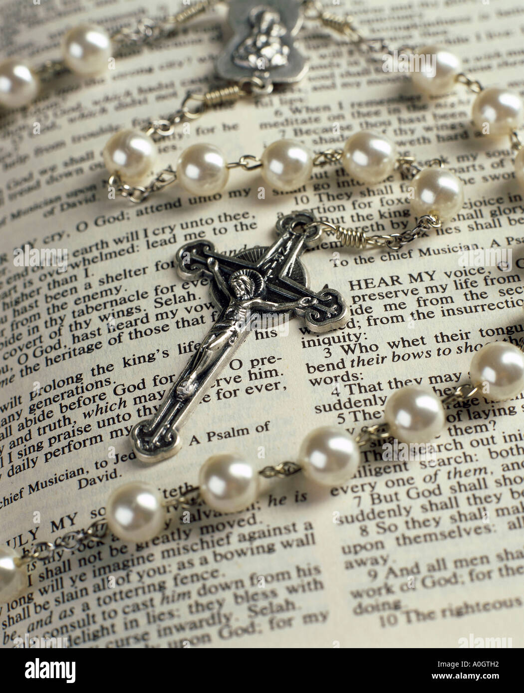 Rosary beads lying on an open Bible Stock Photo - Alamy