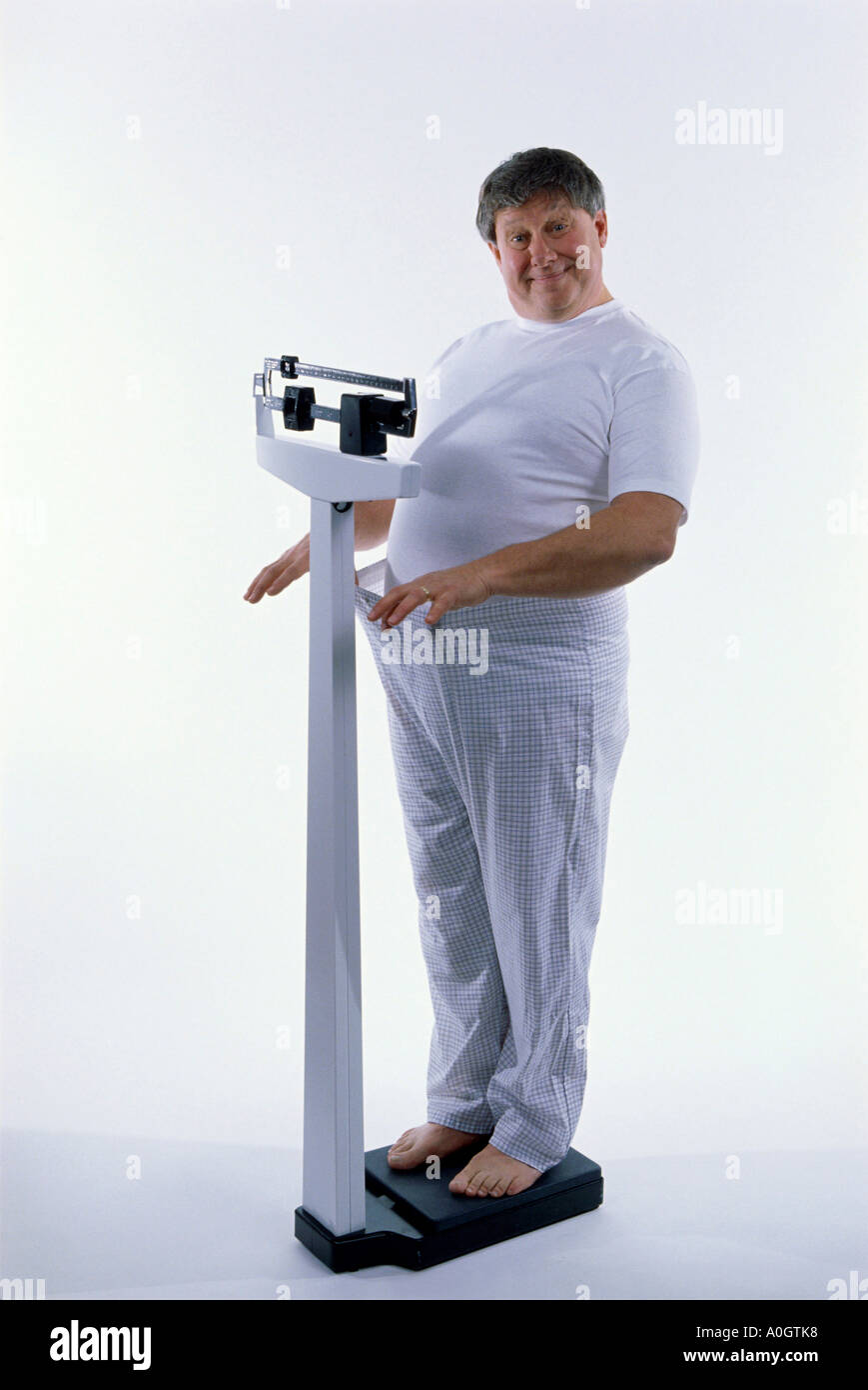Portrait of a man standing on a scale Stock Photo - Alamy