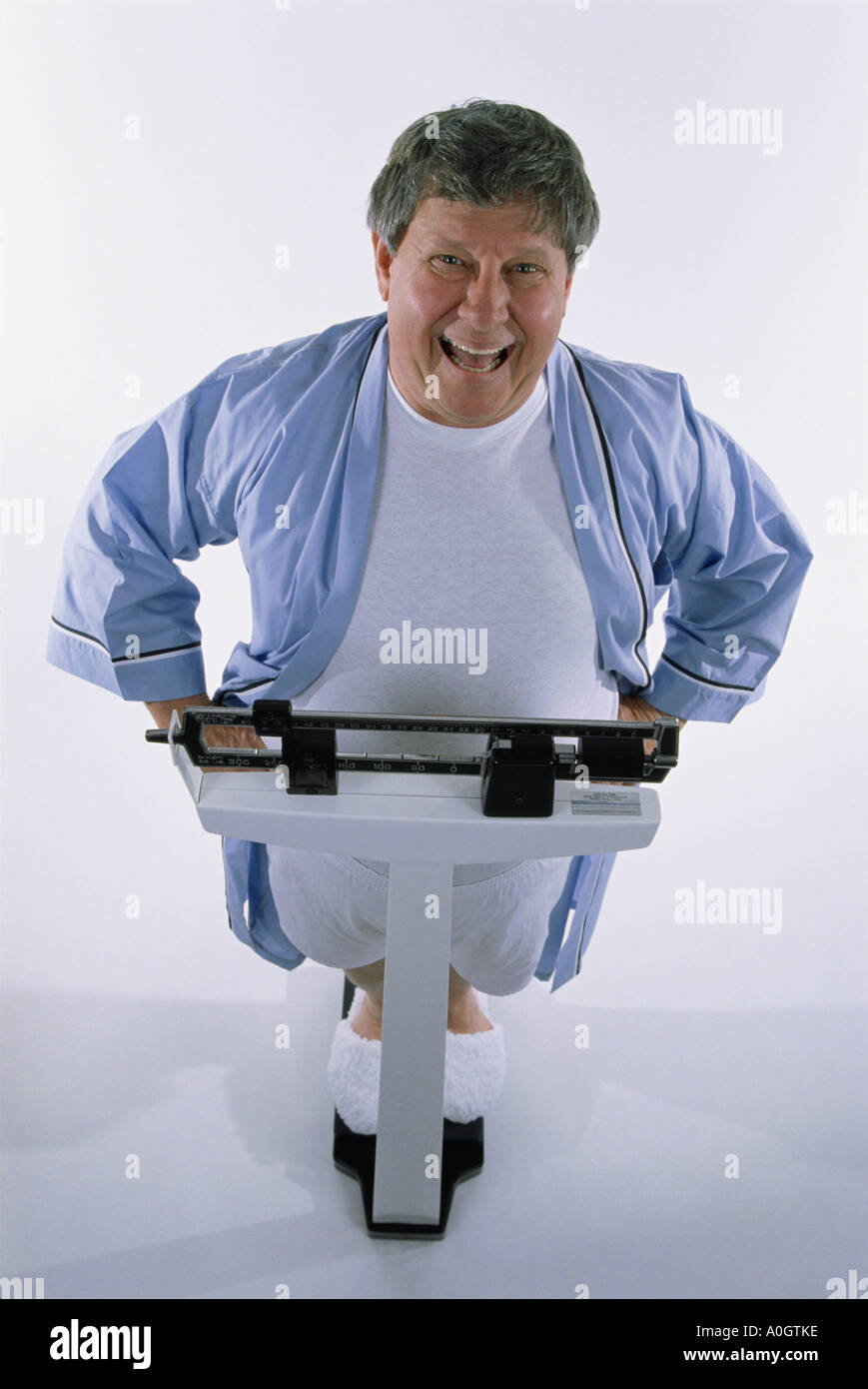 Portrait of a man standing on a scale Stock Photo - Alamy