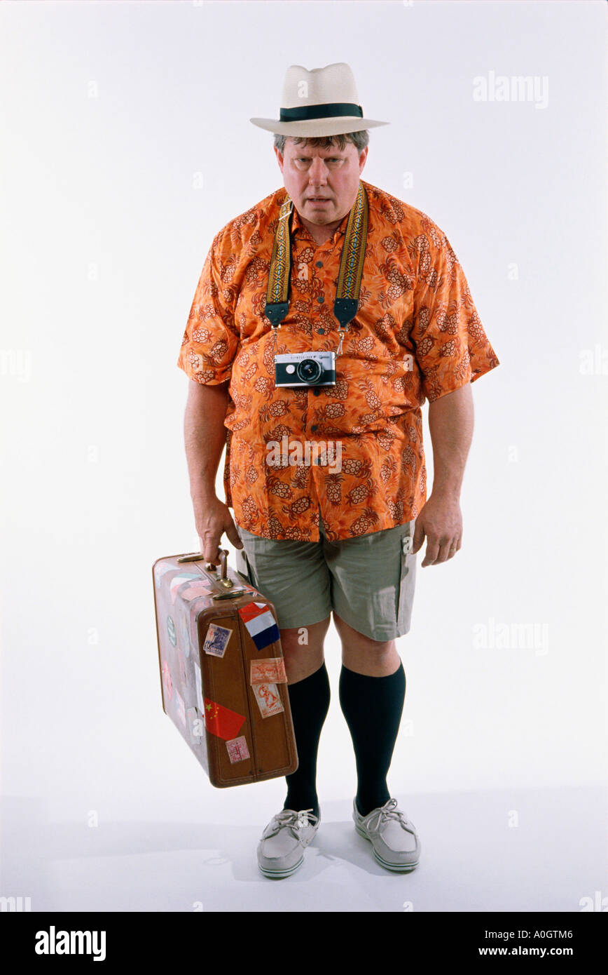 Portrait of a man holding a suitcase Stock Photo - Alamy