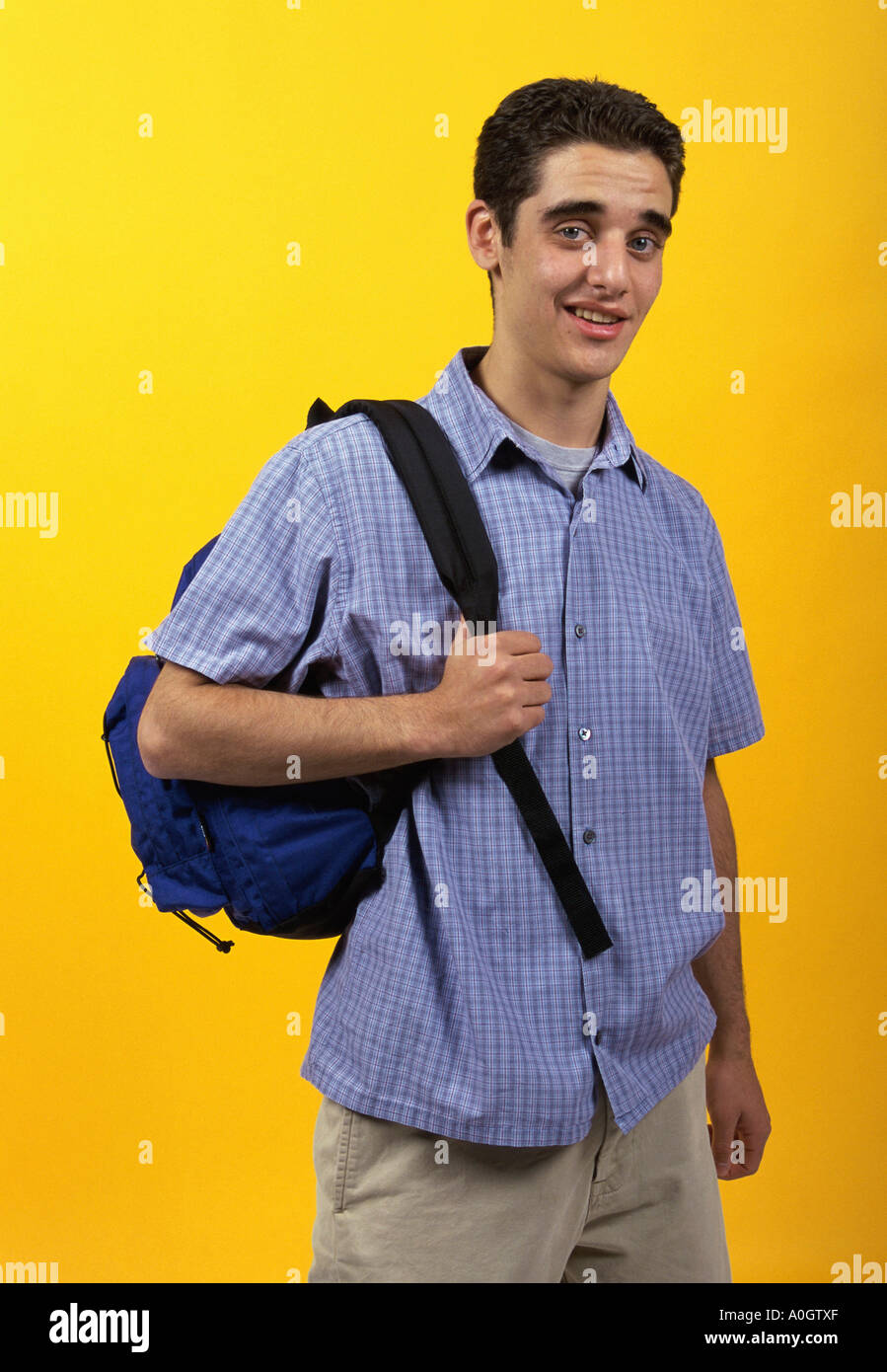 Portrait of a teenage boy carrying a backpack Stock Photo - Alamy