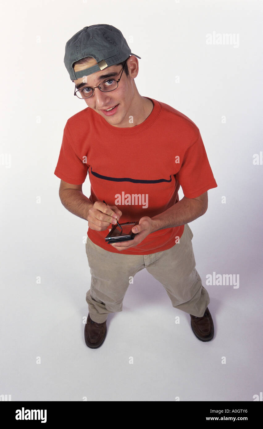 Portrait of a teenage boy holding a hand held device Stock Photo - Alamy