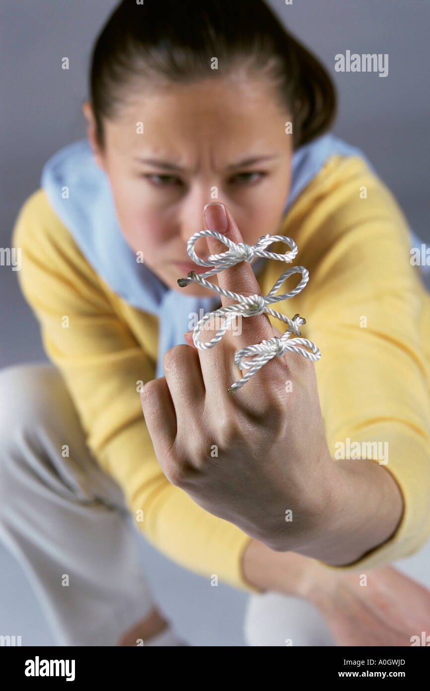 Woman sitting with string tied around her index finger Stock Photo - Alamy