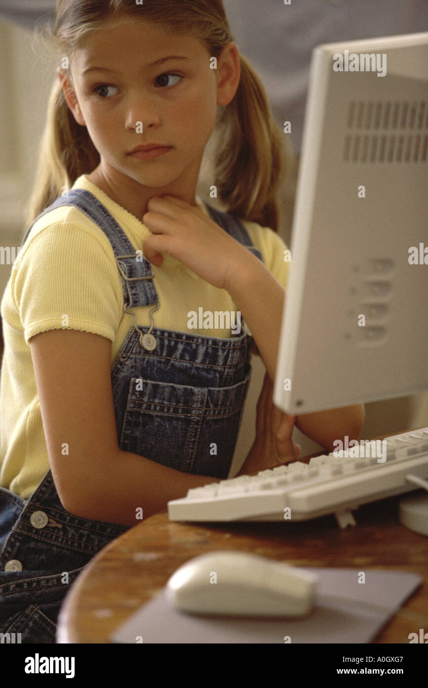 Girl sitting in front of a computer monitor Stock Photo - Alamy