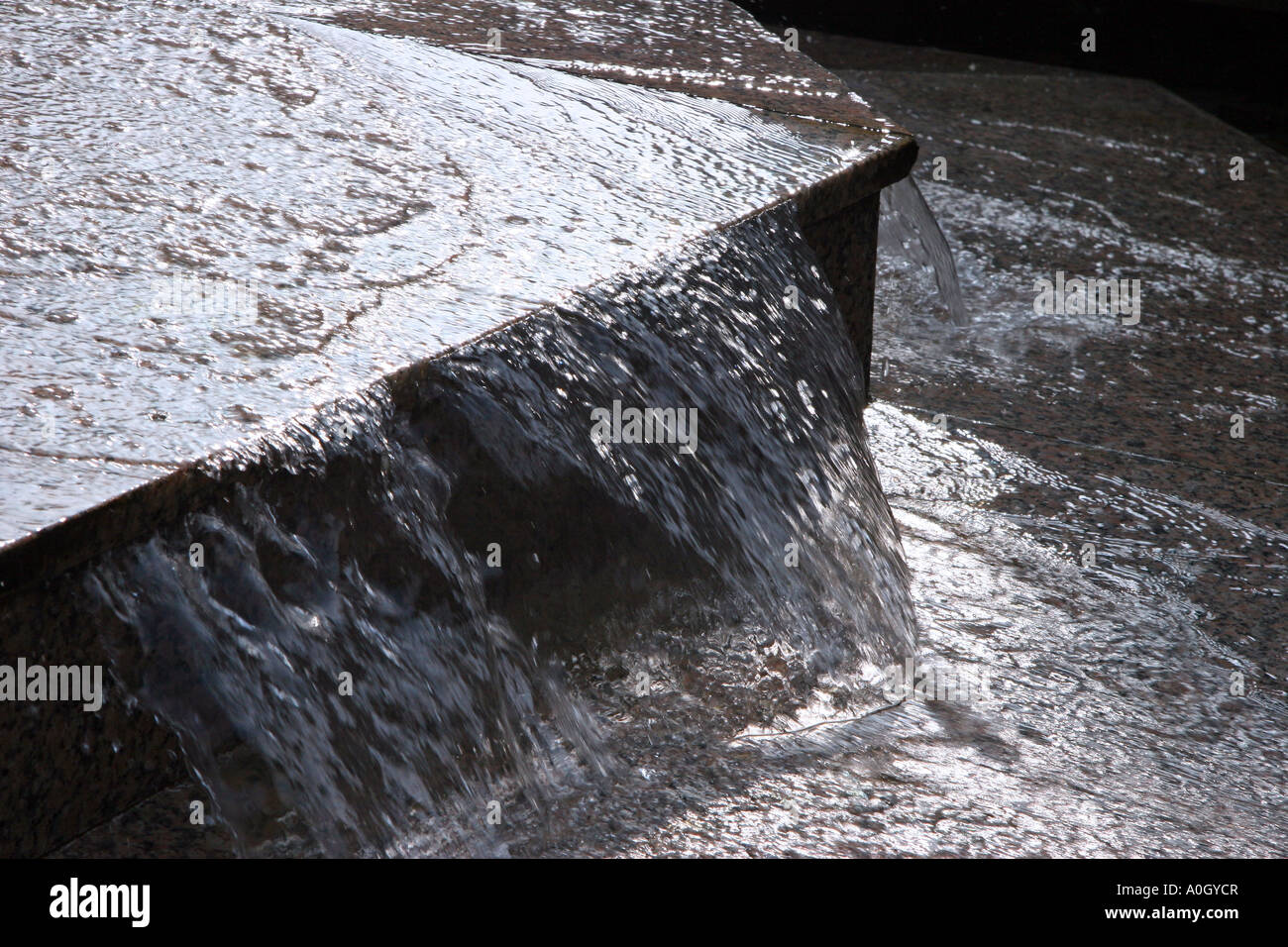 water flowing over a flat stone Stock Photo - Alamy