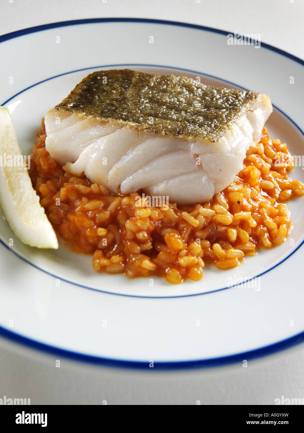 Pan fried cod risotto Stock Photo - Alamy