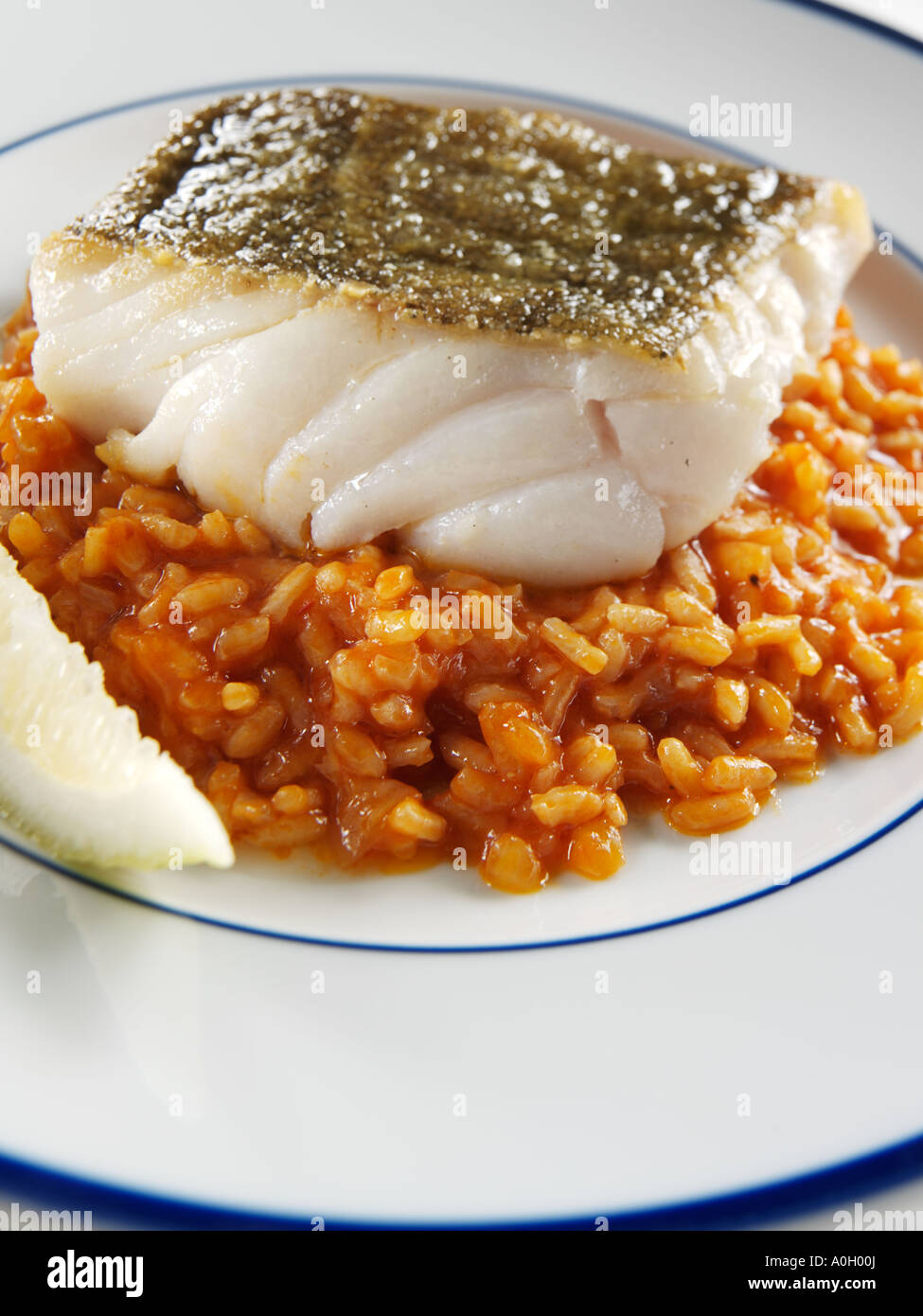 Pan fried cod risotto Stock Photo - Alamy
