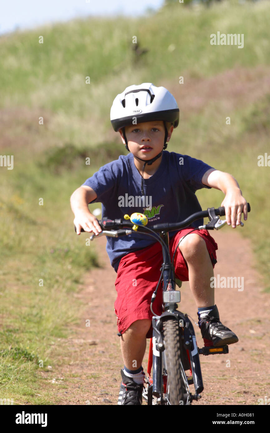 Young boy cycling on track Stock Photo - Alamy