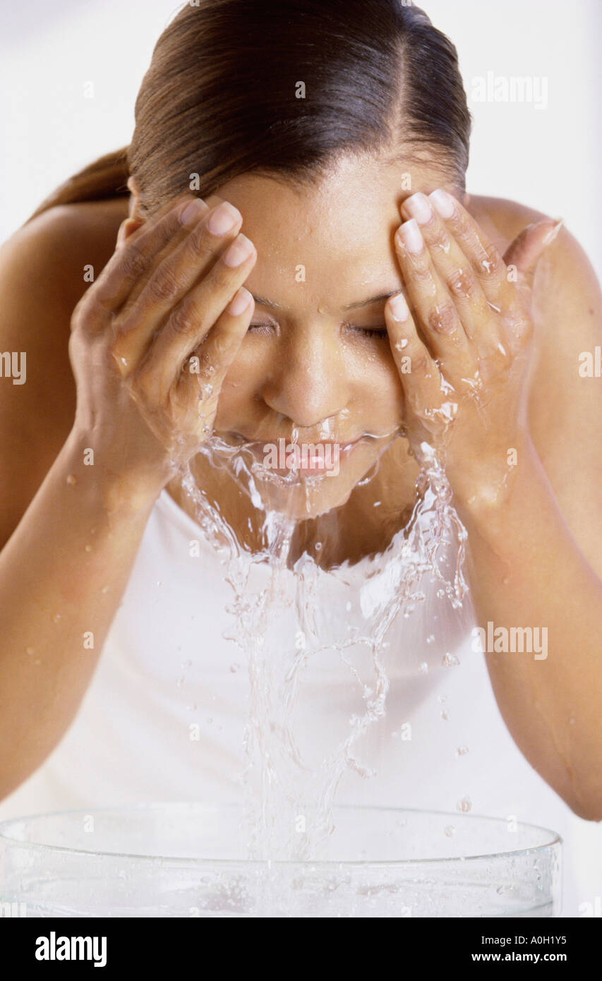 Young woman washing her face Stock Photo - Alamy