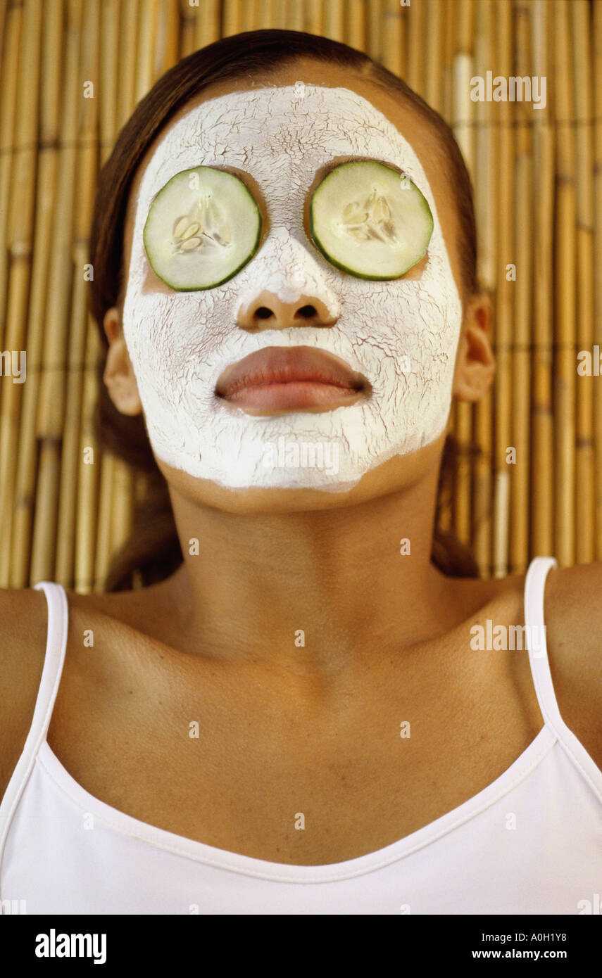 Young woman lying down wearing a facial mask Stock Photo - Alamy