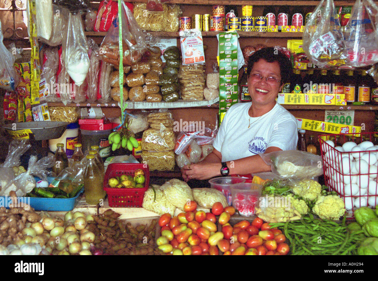Vendor of a produce and supplies at a market stall in Laguna Province ...