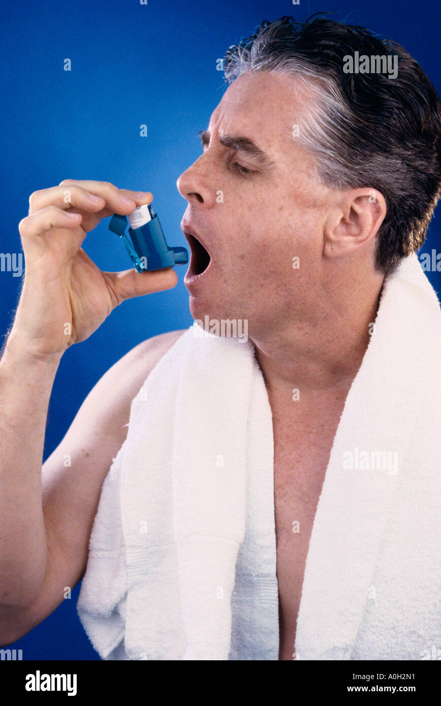 Man using an inhaler Stock Photo - Alamy