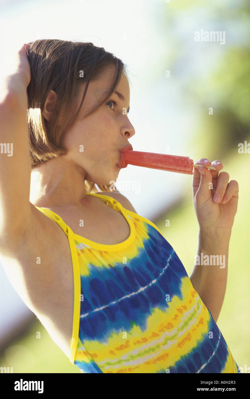 Side profile of a girl eating an ice cream Stock Photo - Alamy