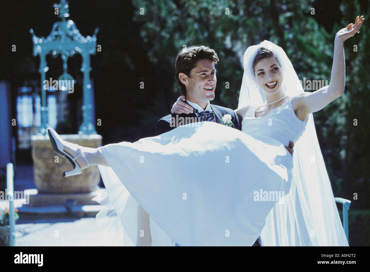 Groom carrying a bride Stock Photo - Alamy