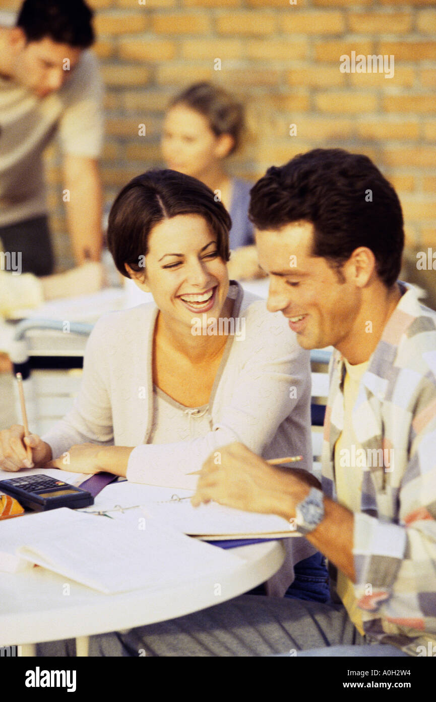 Students sitting together smiling Stock Photo - Alamy