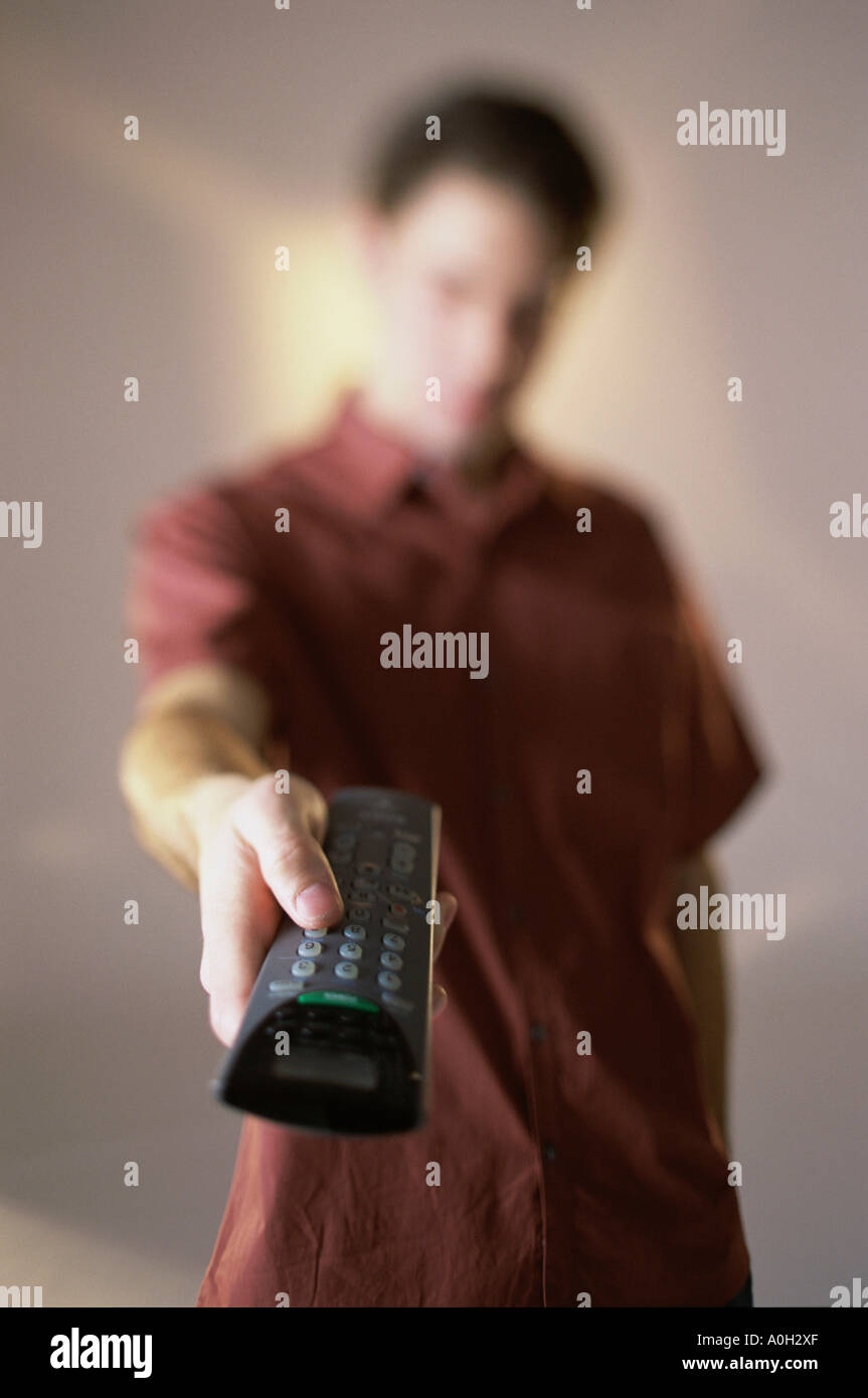 Man holding a remote control Stock Photo - Alamy