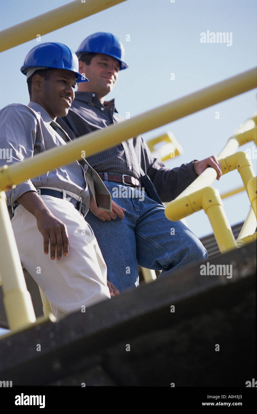 Low angle view of two construction workers Stock Photo - Alamy
