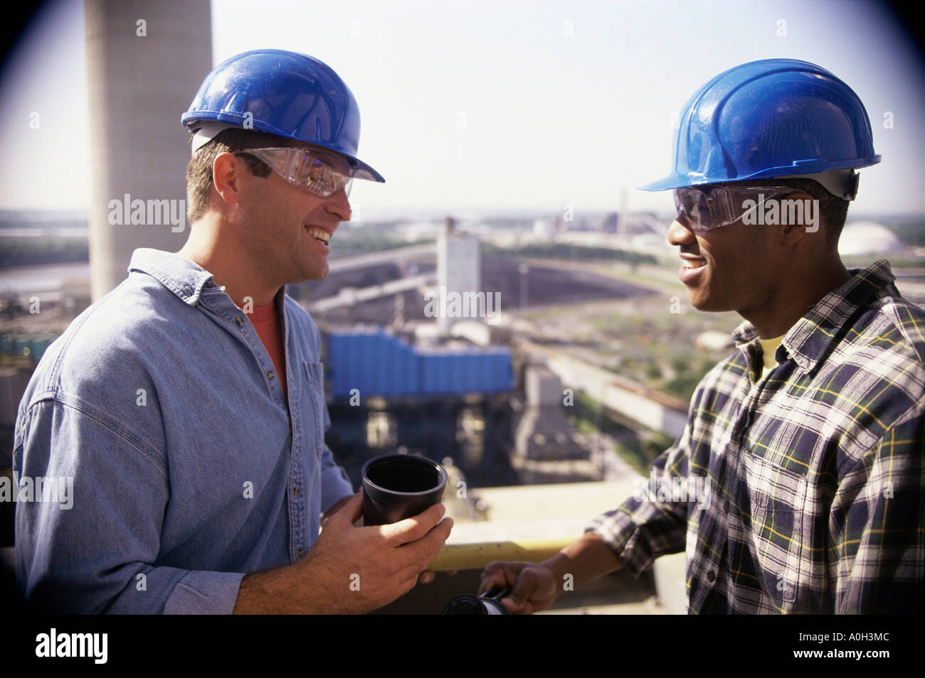 Two construction workers having a coffee break Stock Photo - Alamy
