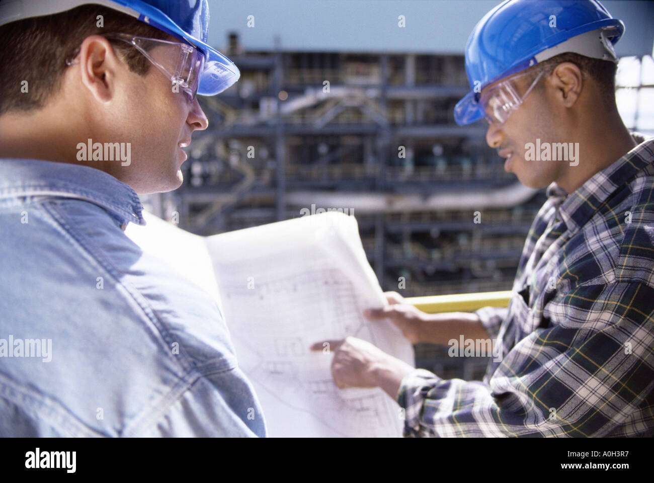 Two foremen working on blueprints Stock Photo - Alamy