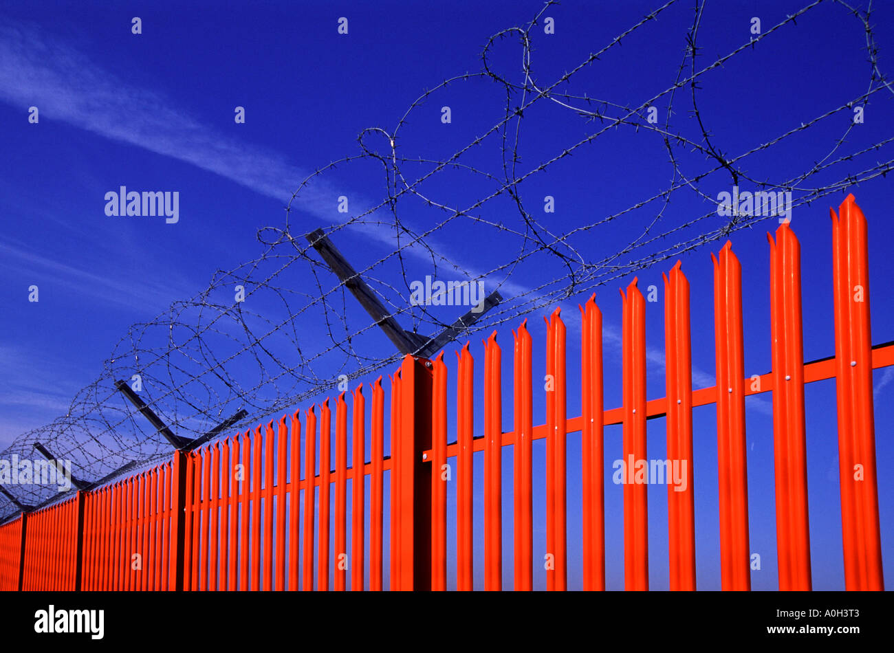 Red security fence Stock Photo - Alamy