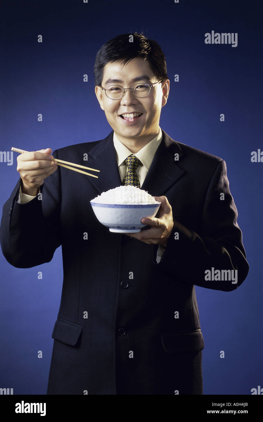 Smiling man with a bowl of rice hi-res stock photography and images - Alamy