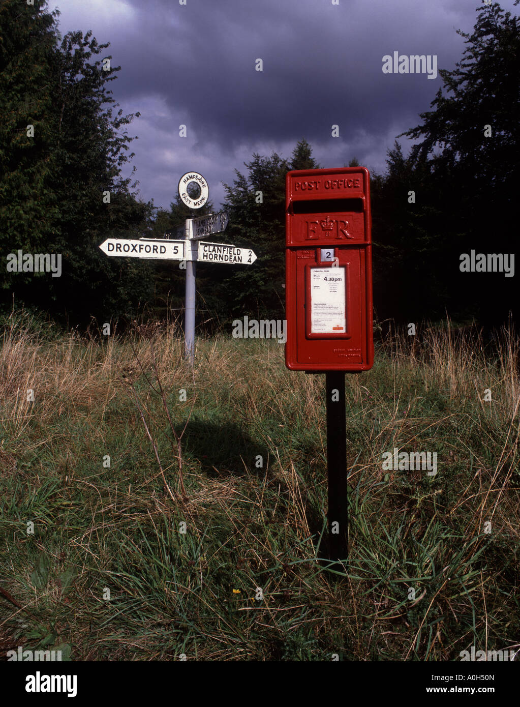 A letter box and road sign at Hyden Hill near Droxford Stock Photo - Alamy