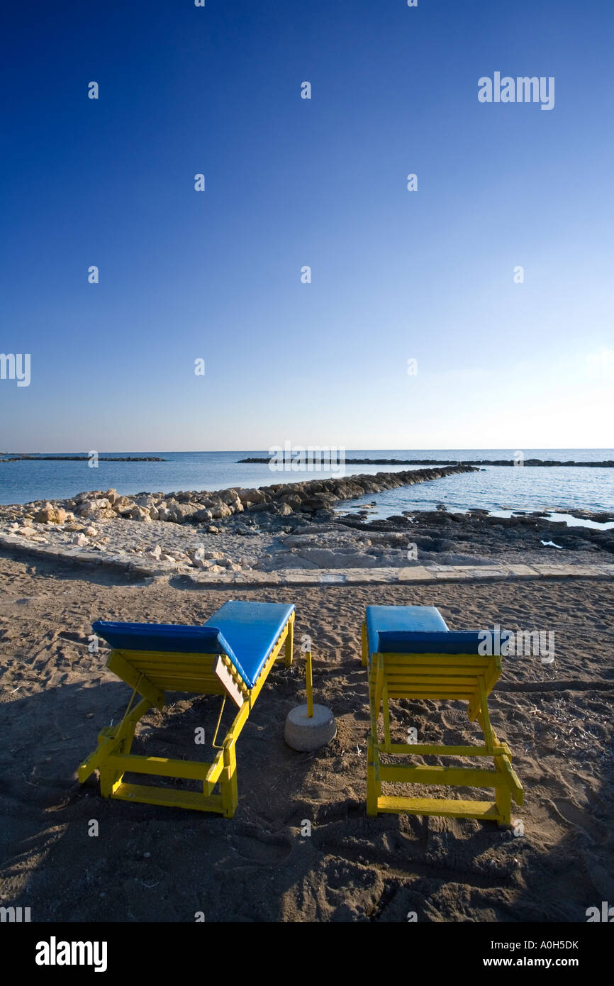 TWO YELLOW DECK CHAIRS ON THE BEACH AT PAPHOS CYPRUS Stock Photo - Alamy