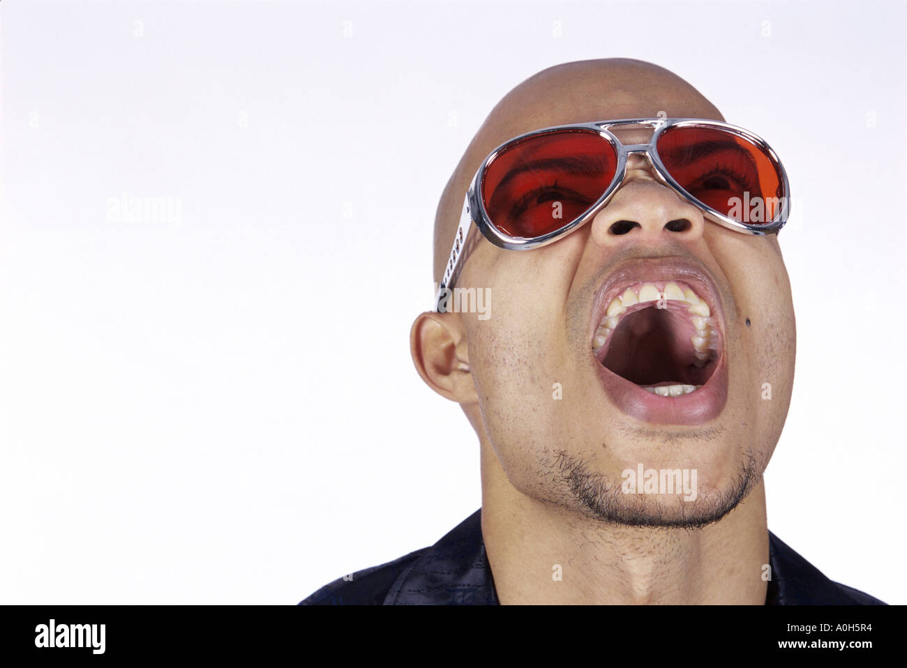 Young man looking up with his mouth wide open Stock Photo - Alamy