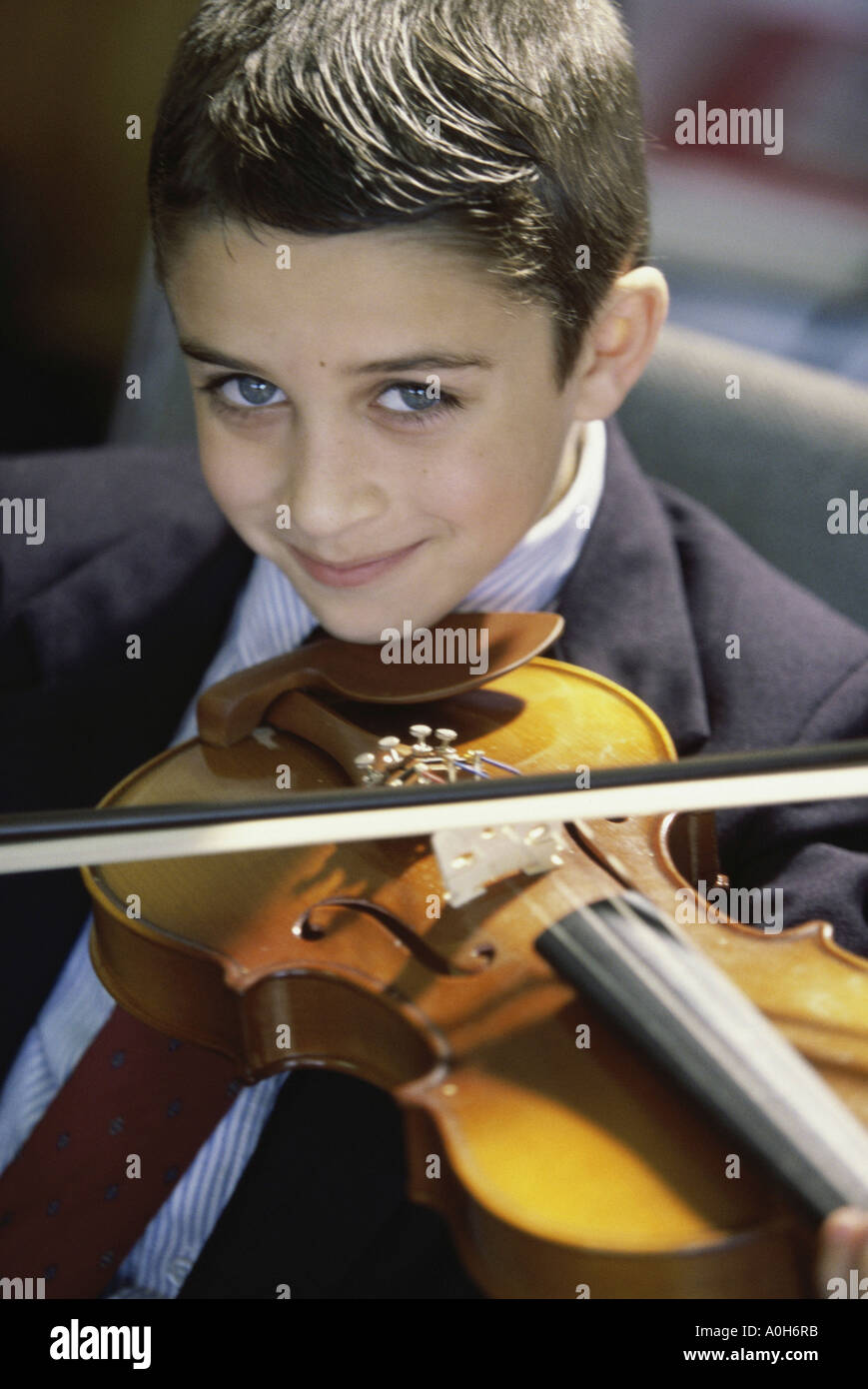 Portrait of a boy playing a violin Stock Photo - Alamy