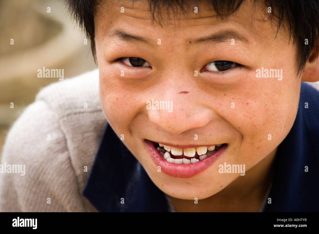 Young Bai boy with cautious smile, Shaping village market, Dali, Yunnan ...