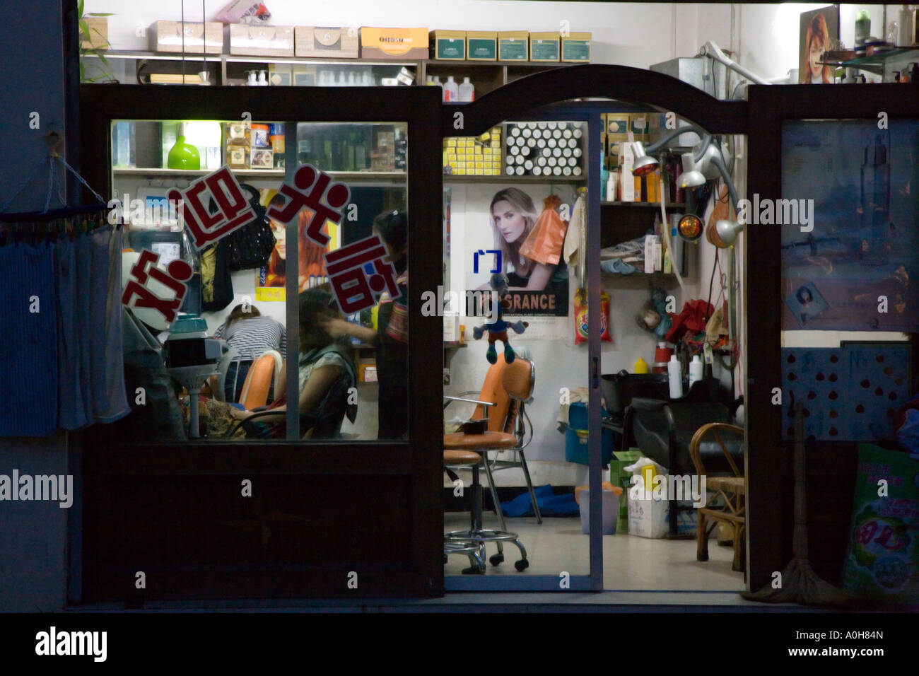 Hairdressing salon at night with dangling stuffed animals, Xinjie village, Yuanyang, Yunnan ...