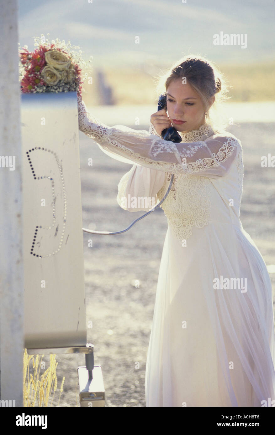 Bride talking on a payphone Stock Photo - Alamy