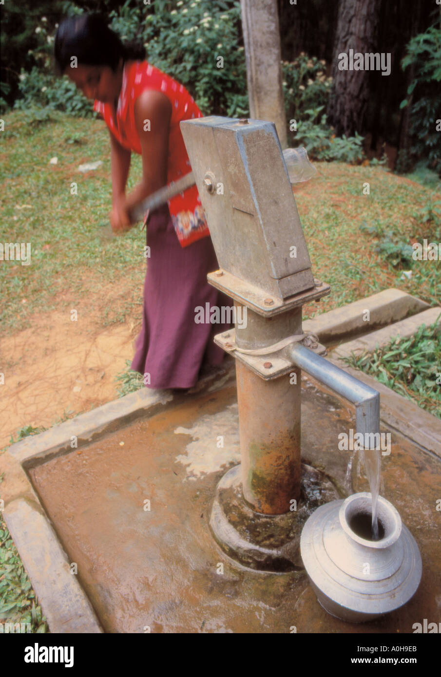 Woman pumping out water Ella Sri Lanka Stock Photo - Alamy