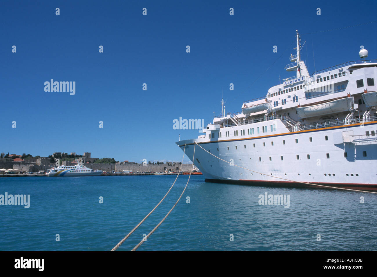 Aegean cruise ship moored in Rhodes harbour with view of the Old Town ...