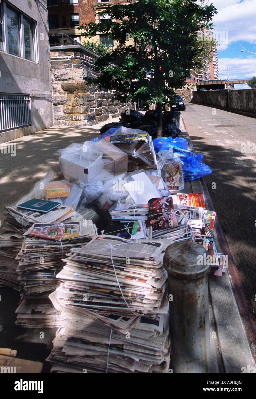Bound old newspapers and plastic garbage bags waiting pickup and ...