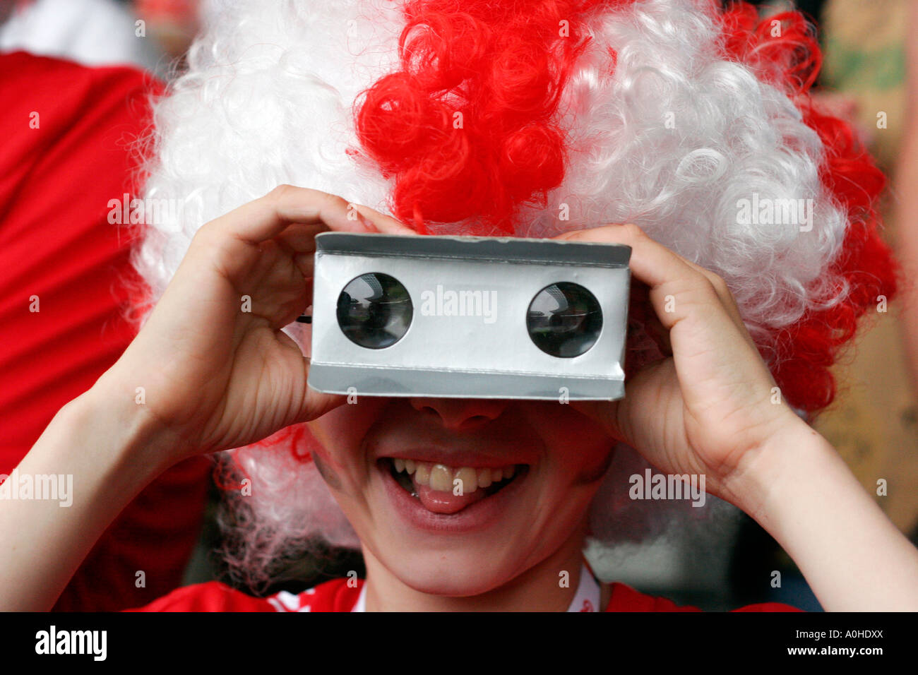 A young England soccer fan uses binoculars to watch the Argentina V ...