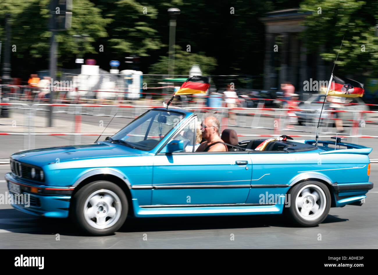 Germany Berlin Summer German cars flying the national flag during the ...