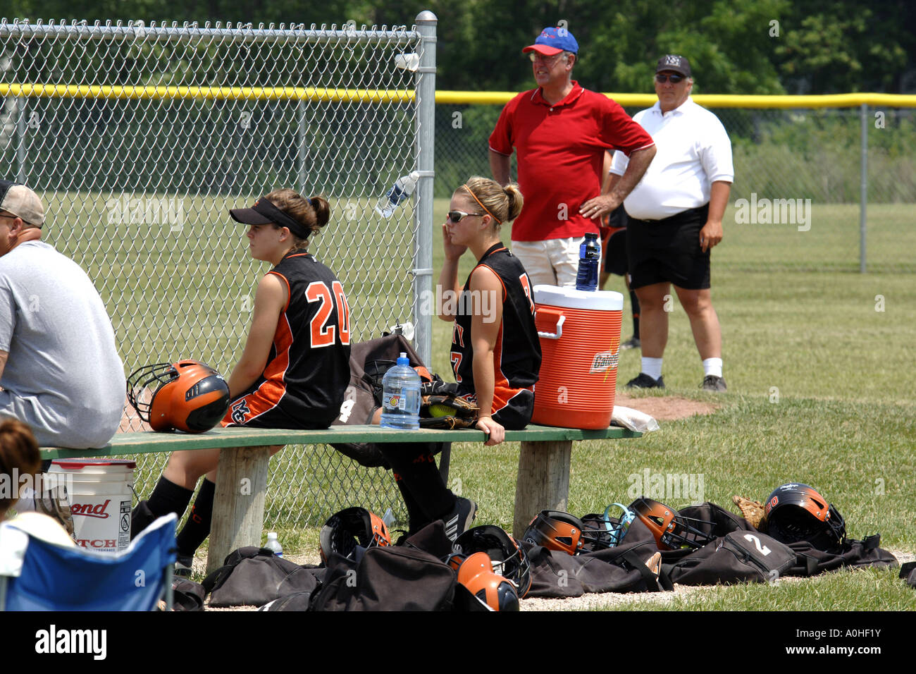 Teenage female major league Softball players sitting on the bench Stock ...